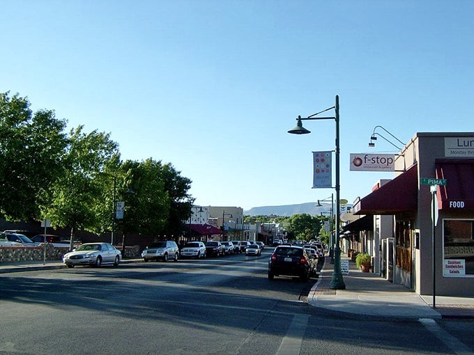 Pedestrians cross the street in downtown Cottonwood, where mountain views and small-town charm create the perfect backdrop for an afternoon wander.