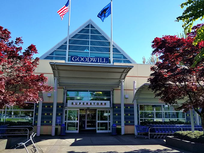 The blue glass peak of this Goodwill superstore catches the morning light. Thrift shopping with a touch of class&mdash;no polyester suit required.