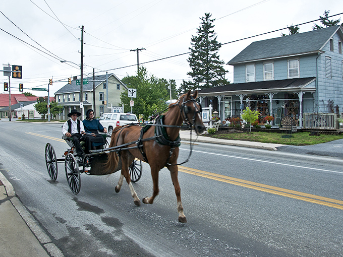 Main Street charm meets horse-drawn tradition as an Amish buggy clip-clops through town, a living postcard of simpler times.