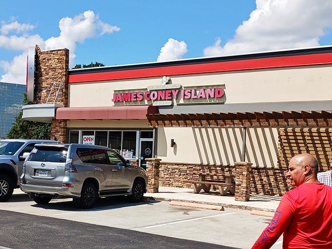 Bright red signage against cream walls &ndash; James Coney Island stands ready to satisfy your hot dog cravings with Texas-sized flavor.