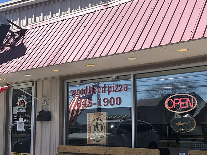 Wood-fired dreams come true behind this unassuming facade. Mr. P's window promises pizza worth calling about.