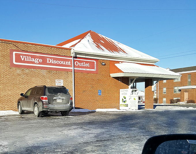 Winter can't freeze the deals at Village Discount Outlet. That red roof is like a lighthouse beacon for the budget-conscious shopper.