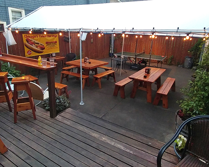Strings of lights and wooden picnic tables create the perfect urban oasis. This cozy patio practically begs you to linger over one more dog and cold beer.