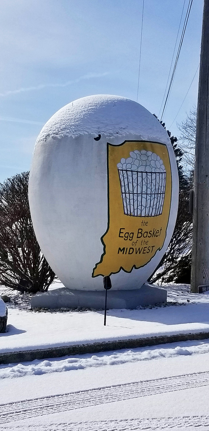 Winter transforms the giant egg into a snow-dusted masterpiece, like nature's own meringue topping on this roadside dessert.