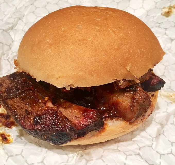 Behold the star attraction: a brisket sandwich sporting that coveted smoke ring. The simple bun knows its role&mdash;just transport this smoky treasure to your face.