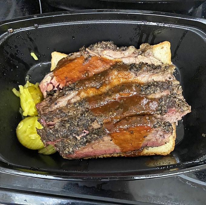 Behold the star of the show: perfectly smoked brisket with that coveted pink smoke ring. Meat candy that makes grown adults weep with joy.