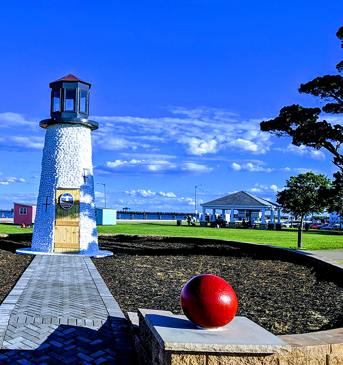 This charming lighthouse stands sentinel at Buckroe Beach, where the red buoy seems to say, "You've found your perfect coastal escape!"