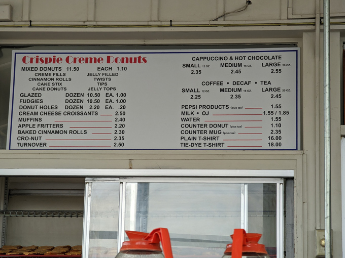 The menu board tells a beautiful story of simplicity – no fancy names, just honest donuts at honest prices.