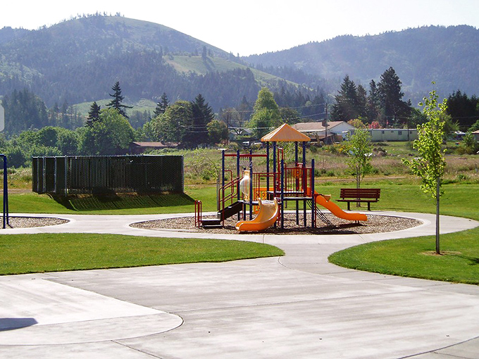 Culbertson Park's playground stands ready for grandkid duty, with mountain views that make even timeout look appealing.