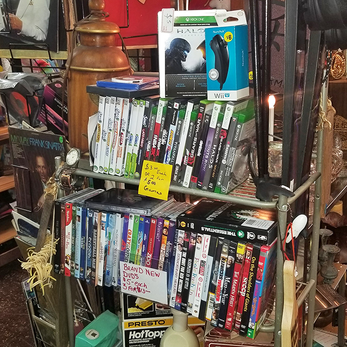 Gaming history lines these shelves, where yesterday's cutting-edge entertainment awaits a second life in someone's living room. That Halo box brings back memories!