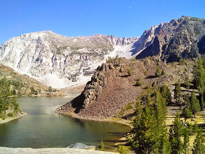 Ellery Lake reflects mountain majesty like nature's own IMAX screen. Just one of countless alpine gems accessible within minutes of Lee Vining's affordable neighborhoods.