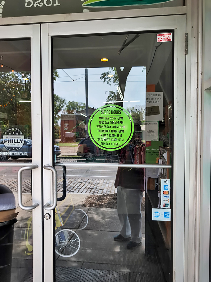 Store hours displayed on a bright green circle&mdash;the portal to bargain paradise awaits six days a week. Sunday is for counting your savings.