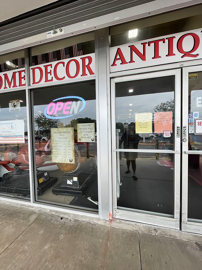 "Home Decor" and "Antiques" promise just a fraction of what awaits beyond those glass doors. The neon "OPEN" sign is your portal to the past.