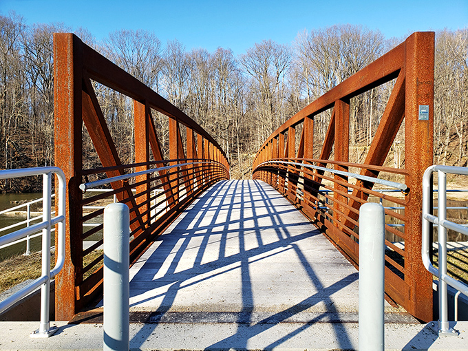 This rustic footbridge isn't just functional&mdash;it's an invitation to adventure, complete with geometric shadows playing across your path.