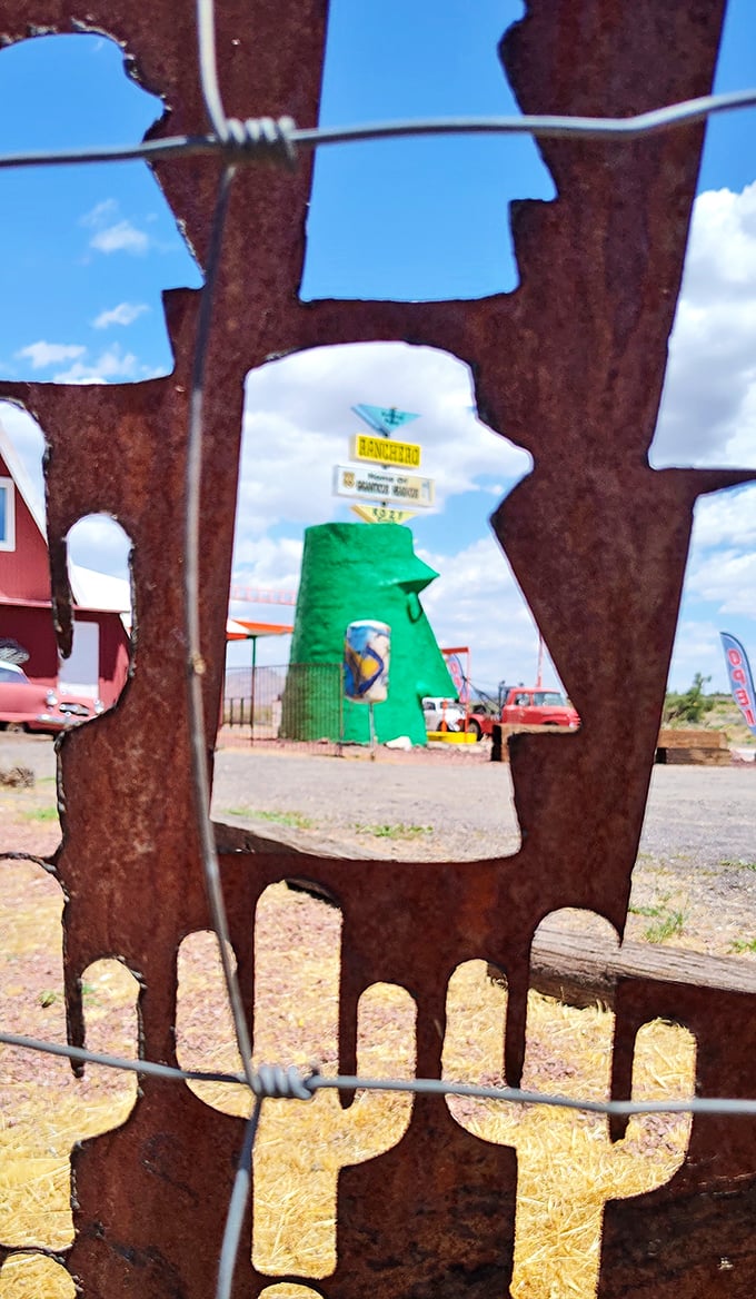 Framed by rustic metal art, the green giant peeks through like a celebrity caught by paparazzi in the wild.