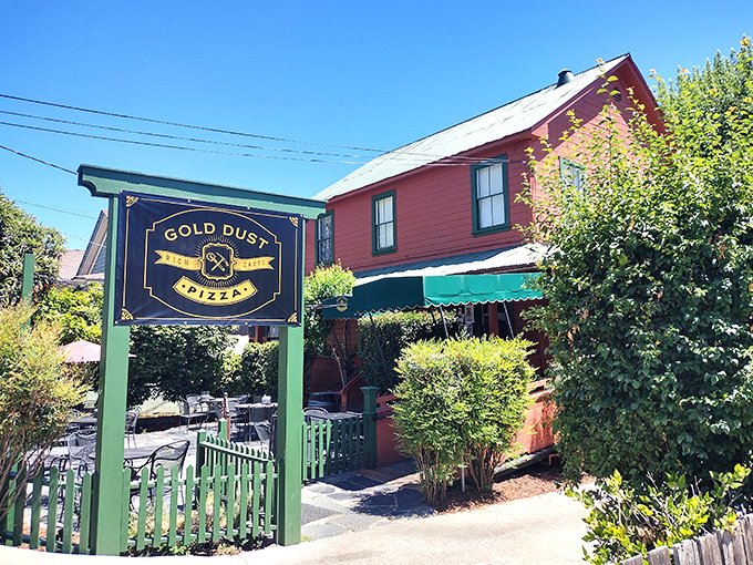 At Gold Dust Pizza, they've struck culinary gold. The charming red building with its inviting patio feels like stepping into a postcard of small-town America.