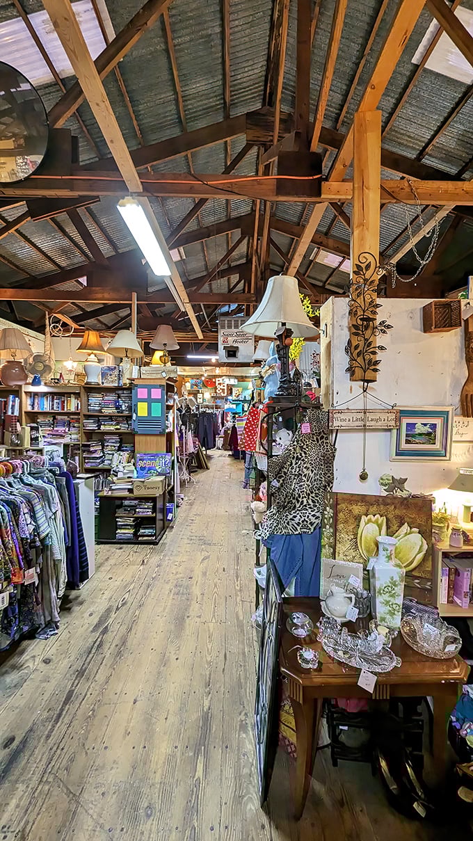 Wooden beams frame a pathway to possibility, where vintage lamps illuminate decades of carefully collected merchandise waiting for new homes.