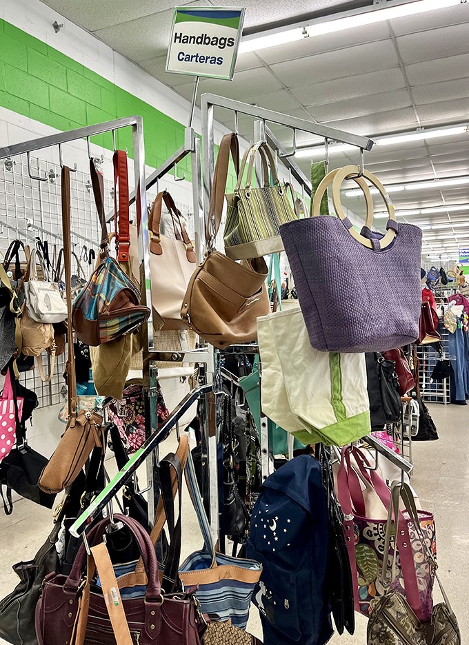 Handbag heaven! Designer dreams and practical purses hang together in democratic fashion, each with stories from previous lives waiting to be continued.