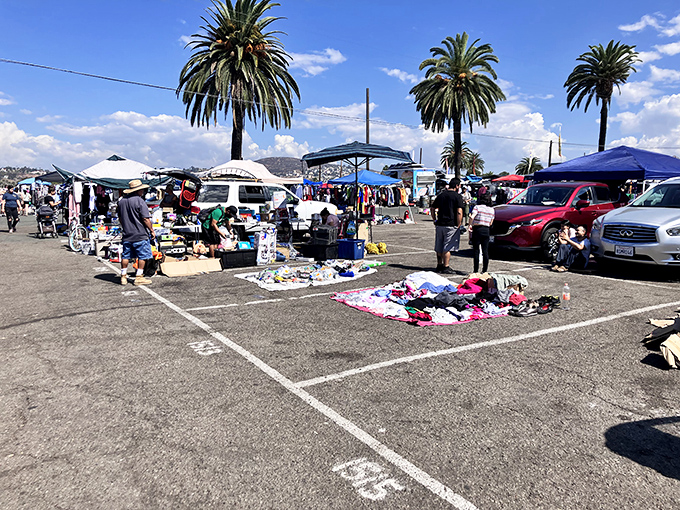 A patchwork of merchandise laid out on blankets creates an impromptu department store in the parking lot.