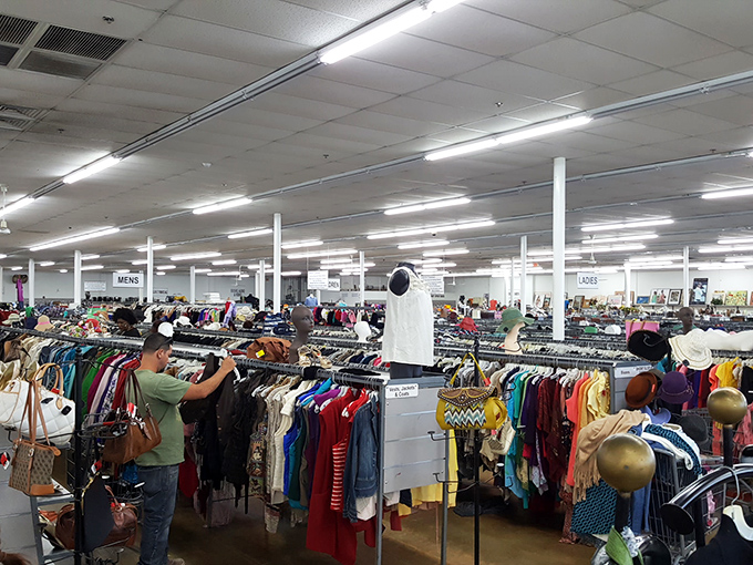 A thrifter's paradise stretches as far as the eye can see, with endless racks creating a labyrinth of potential fashion finds.