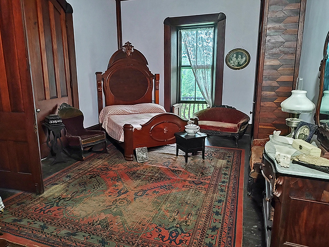 Victorian-era bedroom goals! That ornate headboard and vintage rug would make even the most dedicated IKEA shopper reconsider their life choices.