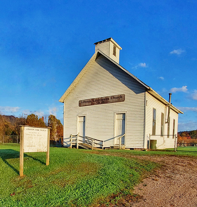 The Lebanon Community Church stands as a serene sentinel against the blue sky, its simple white clapboard design speaking to timeless rural traditions.