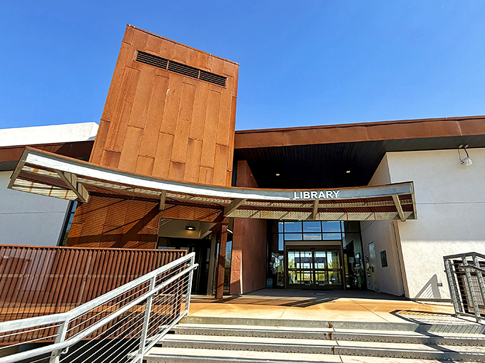 The modern library stands as an architectural oasis of knowledge, its copper accents echoing the desert's warm palette.