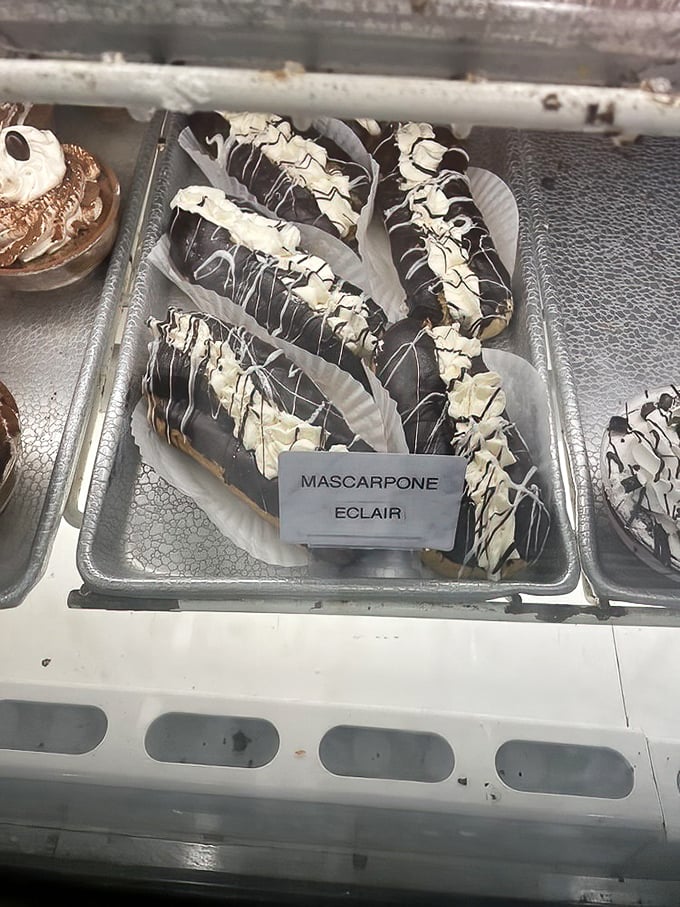 The star of the show: chocolate-draped mascarpone eclairs with white chocolate drizzle - architecture of deliciousness that would make Michelangelo weep.