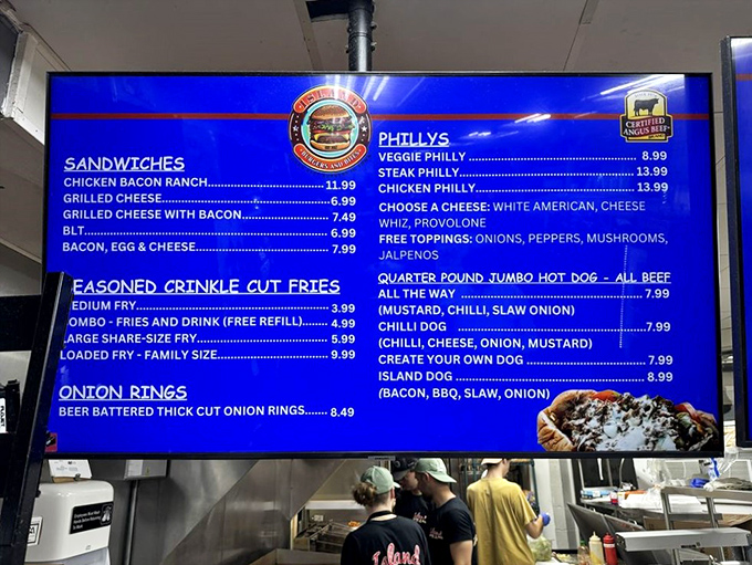That glowing blue menu board is basically a choose-your-own-adventure book where every path leads to delicious defeat.