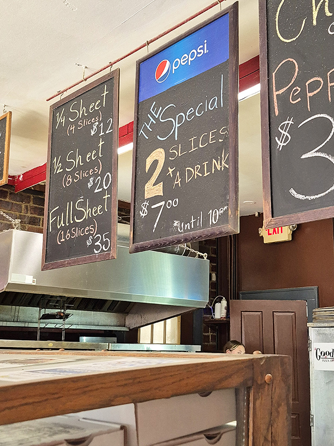 Simple menu, complex flavors. The chalkboard offerings promise pizza paradise without overwhelming you with choices.