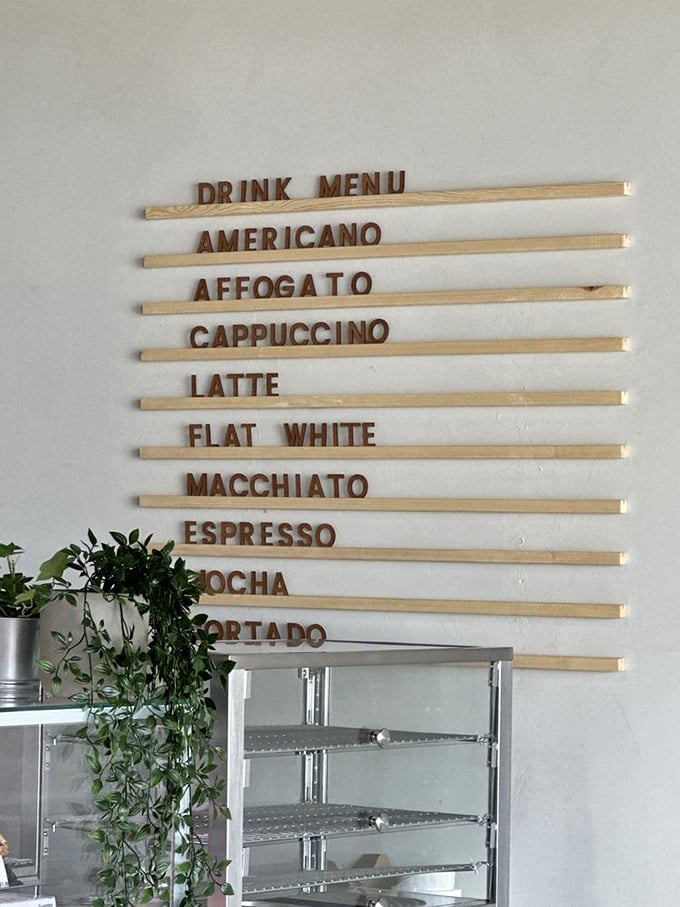 Coffee options lined up like delicious soldiers ready for duty. The wooden menu board is both rustic and sophisticated&mdash;just like the beverages it advertises.