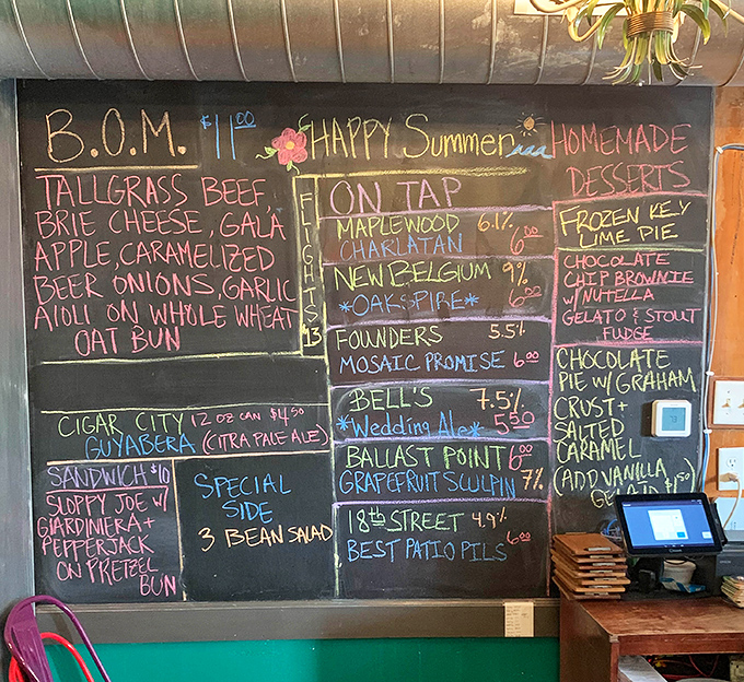 The chalkboard menu reads like a love letter to creative burger craftsmanship, with local beers to match every imaginative offering.