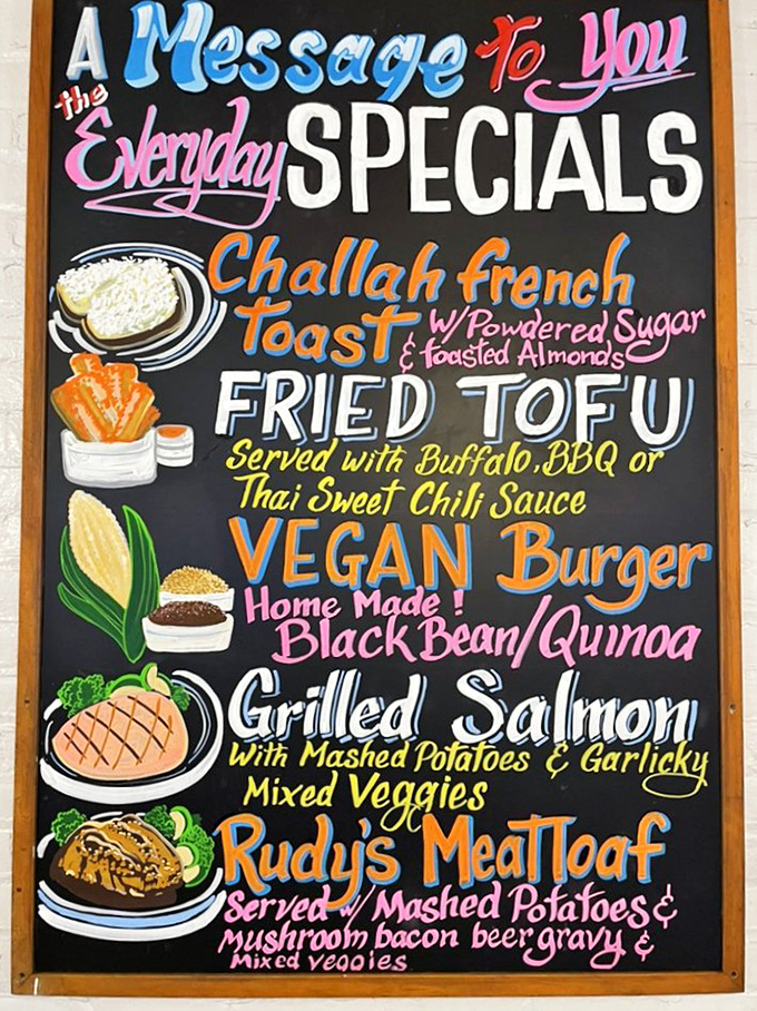 The colorful chalkboard menu reads like a love letter to comfort food, with challah French toast and homemade meatloaf stealing the spotlight.