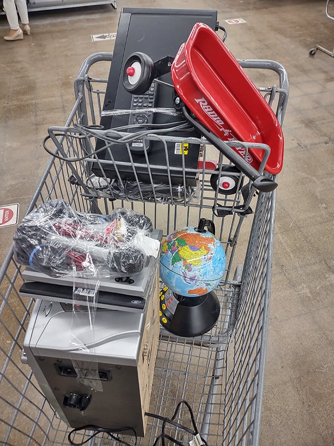 One shopper's "I don't need this anymore" becomes another's "How did I live without this?" A cart filled with electronic treasures and a mini globe.