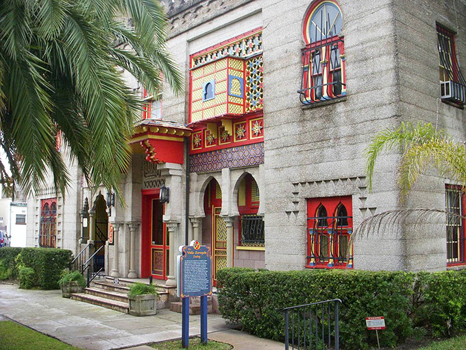 Palm trees frame this Moorish fantasy like nature's exclamation points. The red-trimmed windows and horseshoe arches aren't just design choices&mdash;they're love letters to the Alhambra.