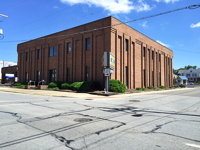 This sturdy brick building anchors a corner of downtown, its solid presence a testament to small-town America's enduring architectural heritage.