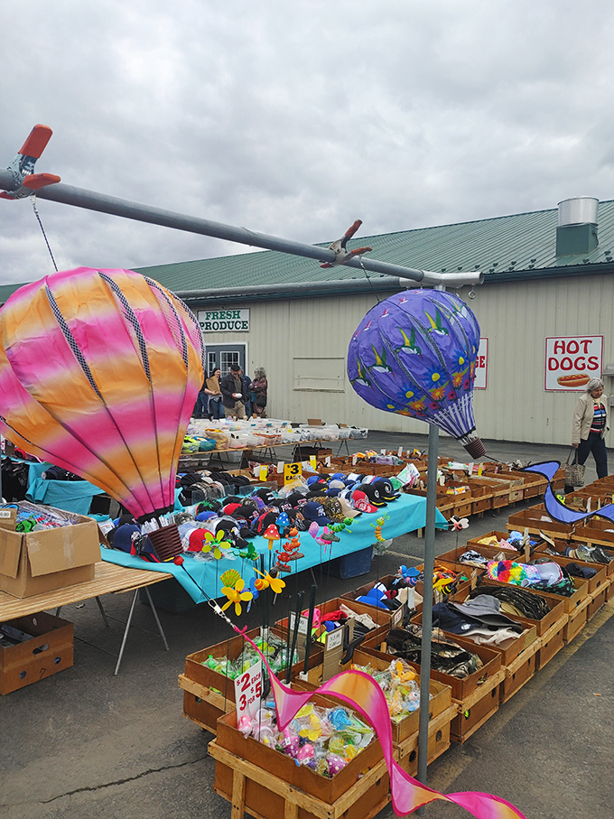 Whimsical hot air balloons hover above a sea of colorful trinkets, creating a carnival atmosphere that makes even serious antiquers smile.