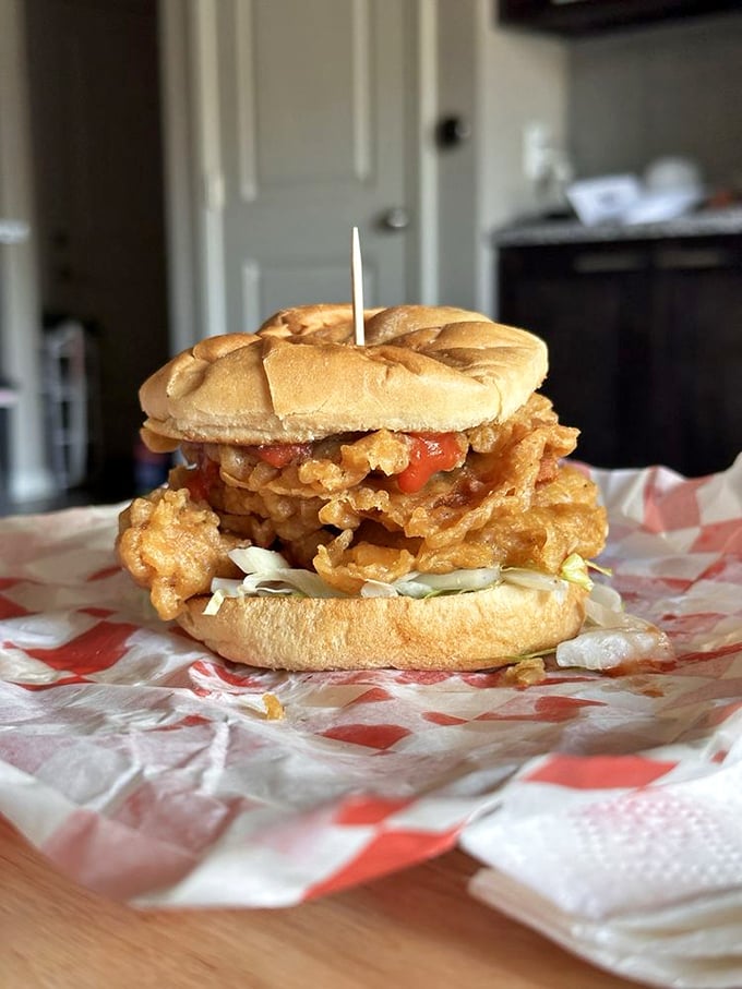 The star of the show! Golden-fried pork tenderloin spilling beyond its bun borders, a masterpiece of crunch and tenderness worth every napkin.