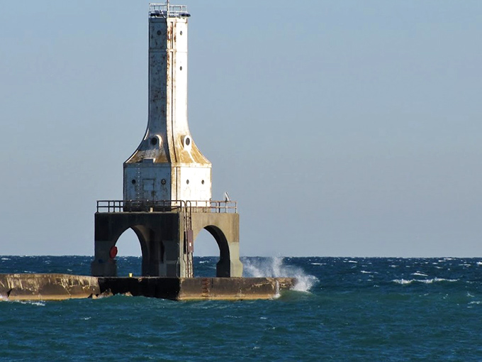 The Port Washington lighthouse isn't just photogenic – it's a sentinel with purpose. When Lake Michigan gets moody, those arched openings allow waves to pass through rather than topple the structure.