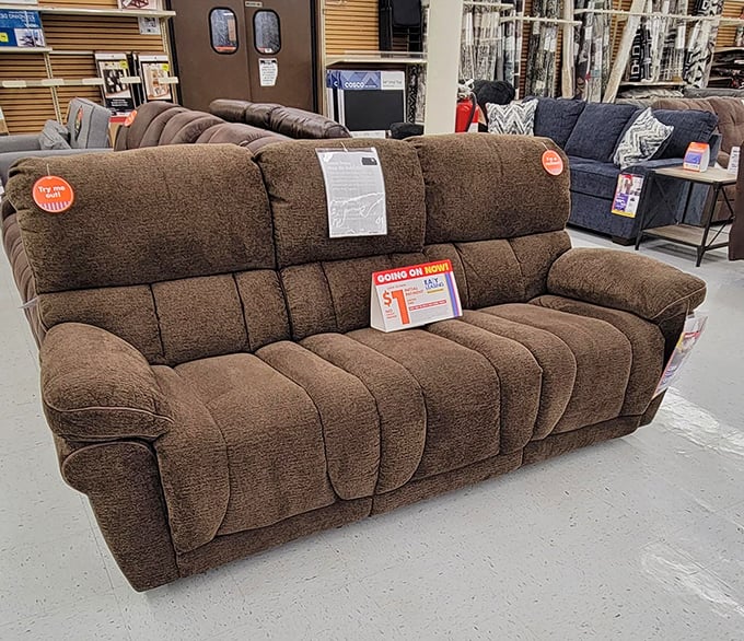 This plush brown reclining sofa isn't just furniture; it's an invitation to sink in, kick back, and contemplate life's big questions&mdash;like what else you might need from aisle seven.