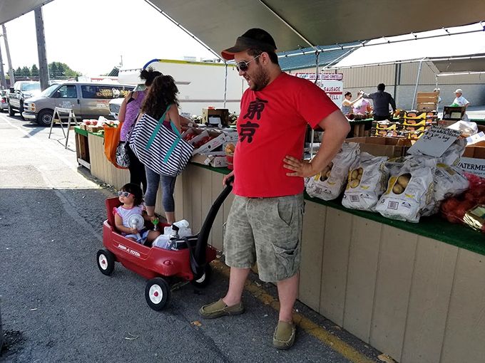 Family outings take on new meaning when there's a little red wagon involved. This dad's "what did I get myself into?" expression is universal flea market language.