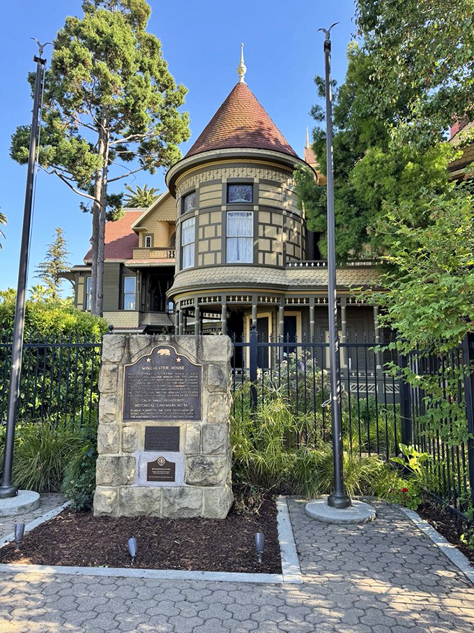 The historical marker stands guard at the entrance, a formal introduction to California's most beautifully bizarre home. Like meeting someone normal before discovering they collect vintage dental equipment.