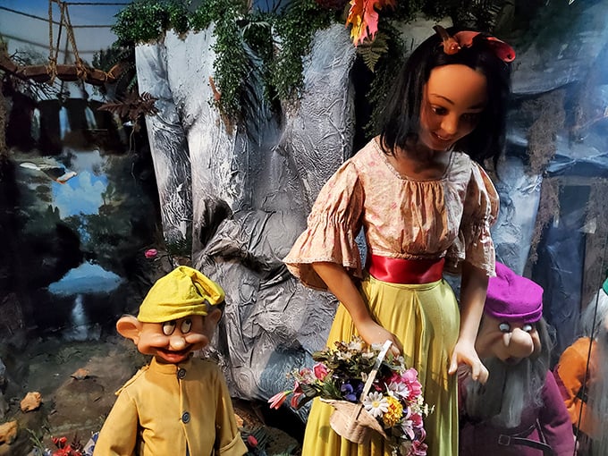 Snow White's frozen smile tells a thousand stories while her dwarf companions look on with expressions ranging from mildly confused to vaguely suspicious.