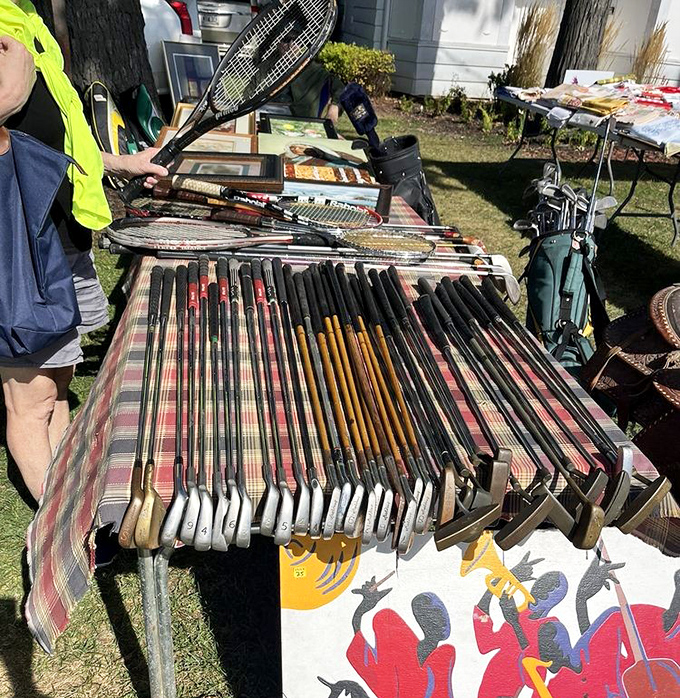 Fore! A collection of vintage golf clubs and tennis rackets stands ready for a second swing at life—sporting equipment with stories to tell.