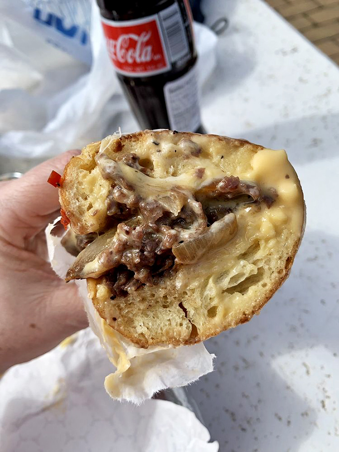 Behold the star attraction: shaved ribeye, melty cheese, and caramelized onions creating what can only be described as a religious experience between bread.