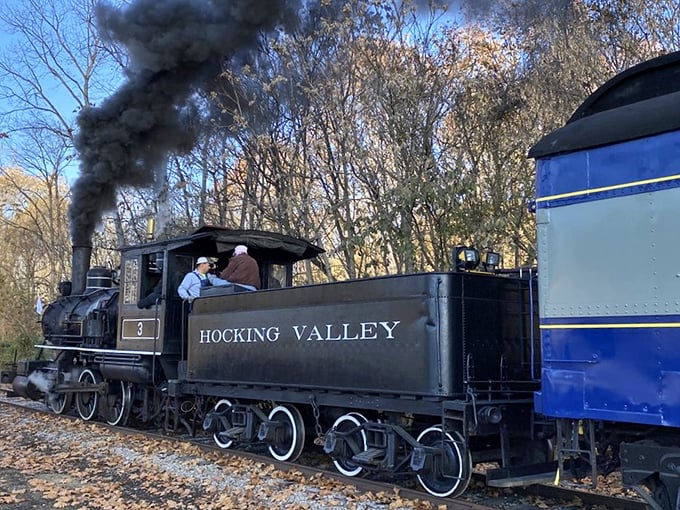 Poetry in motion: The Hocking Valley steam locomotive puffs dramatically against autumn trees, painting the sky with wisps of industrial-era nostalgia.