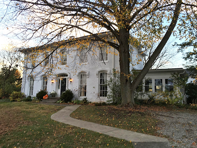 The Orchard House stands gracefully under autumn's canopy, proving that some homes age better than Hollywood stars.