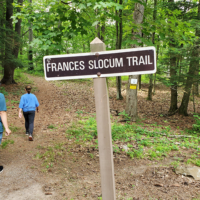 The Frances Slocum Trail beckons hikers into a leafy embrace. Some paths you follow, others you let lead you&mdash;this one promises both.