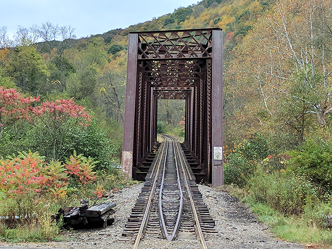 Fall's fiery colors frame this railroad trestle, a reminder of when trains carried black gold from this valley to the world.