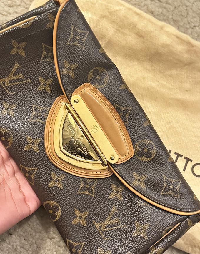 This authentic Louis Vuitton clutch shows the gentle patina of light use—what fashion connoisseurs call "character" and bargain hunters call "jackpot!"